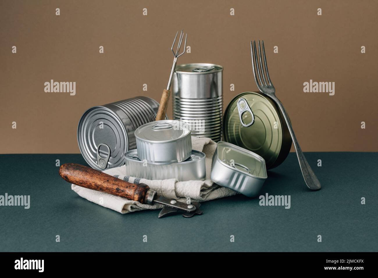 Stacked unopened cans on cloth on a brown and green background Stock ...