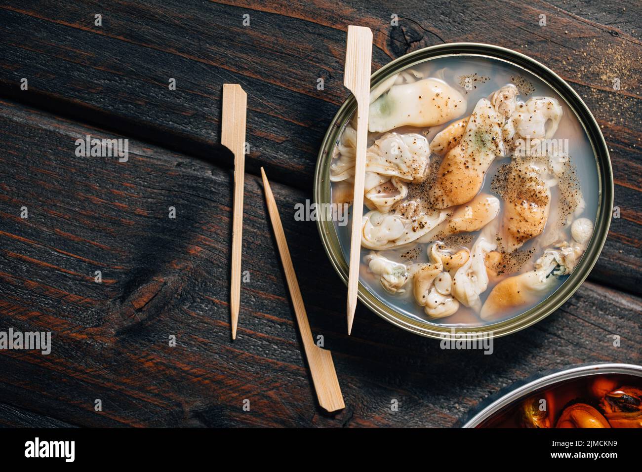From above cans of preserved clams on a wood background Stock Photo - Alamy