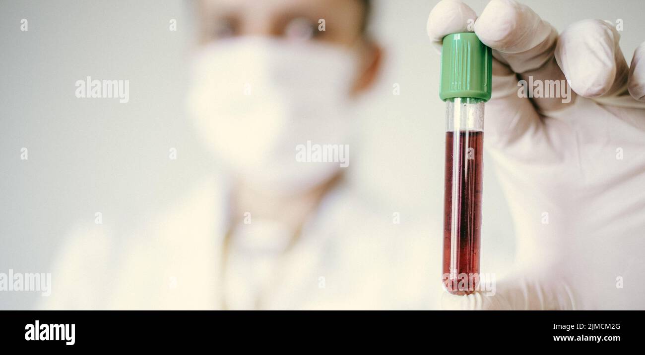 Female doctor holding a blood test sample coronavirus Stock Photo - Alamy