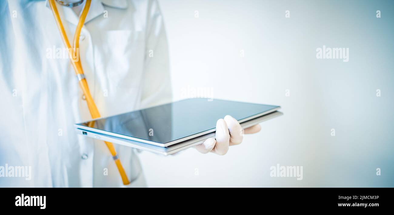 Doctor working on tablet medical care Stock Photo - Alamy