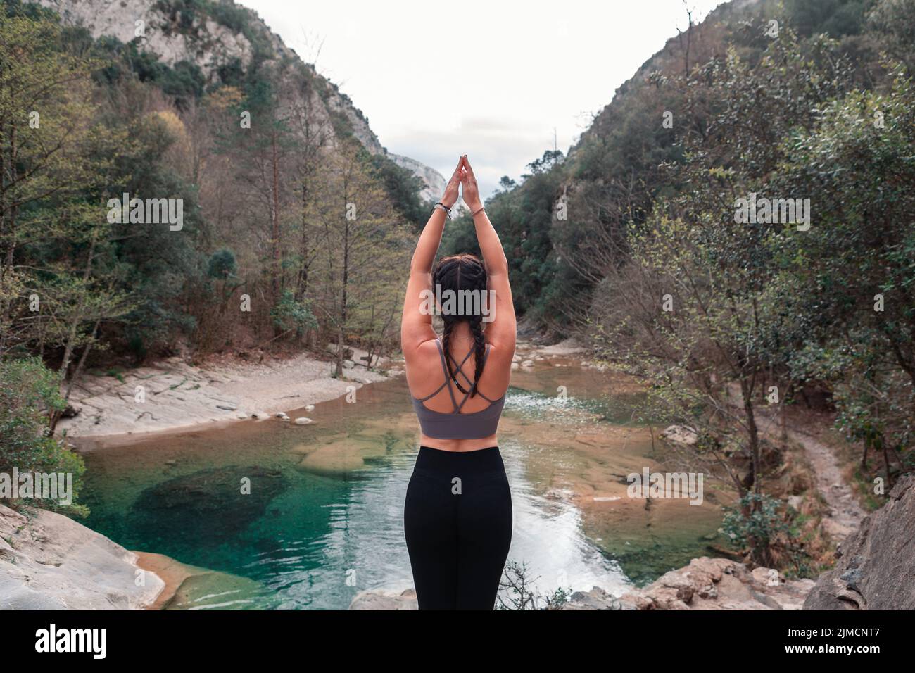 Back view anonymous woman practicing yoga in the river Stock Photo - Alamy