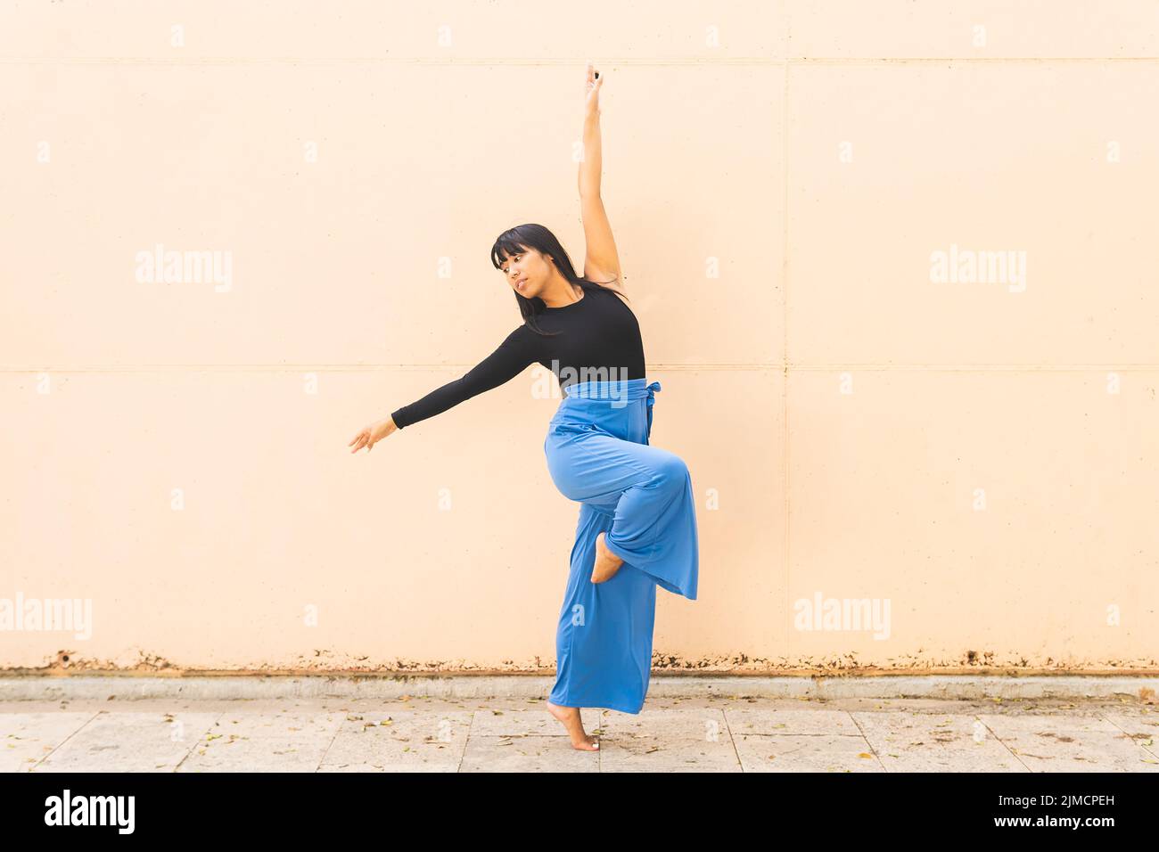 Full body flexible Asian woman with long hair raising leg and ...