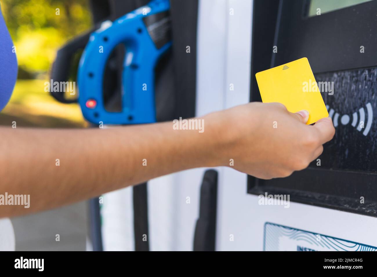 Crop anonymous female paying for filling automobile with credit card at ...