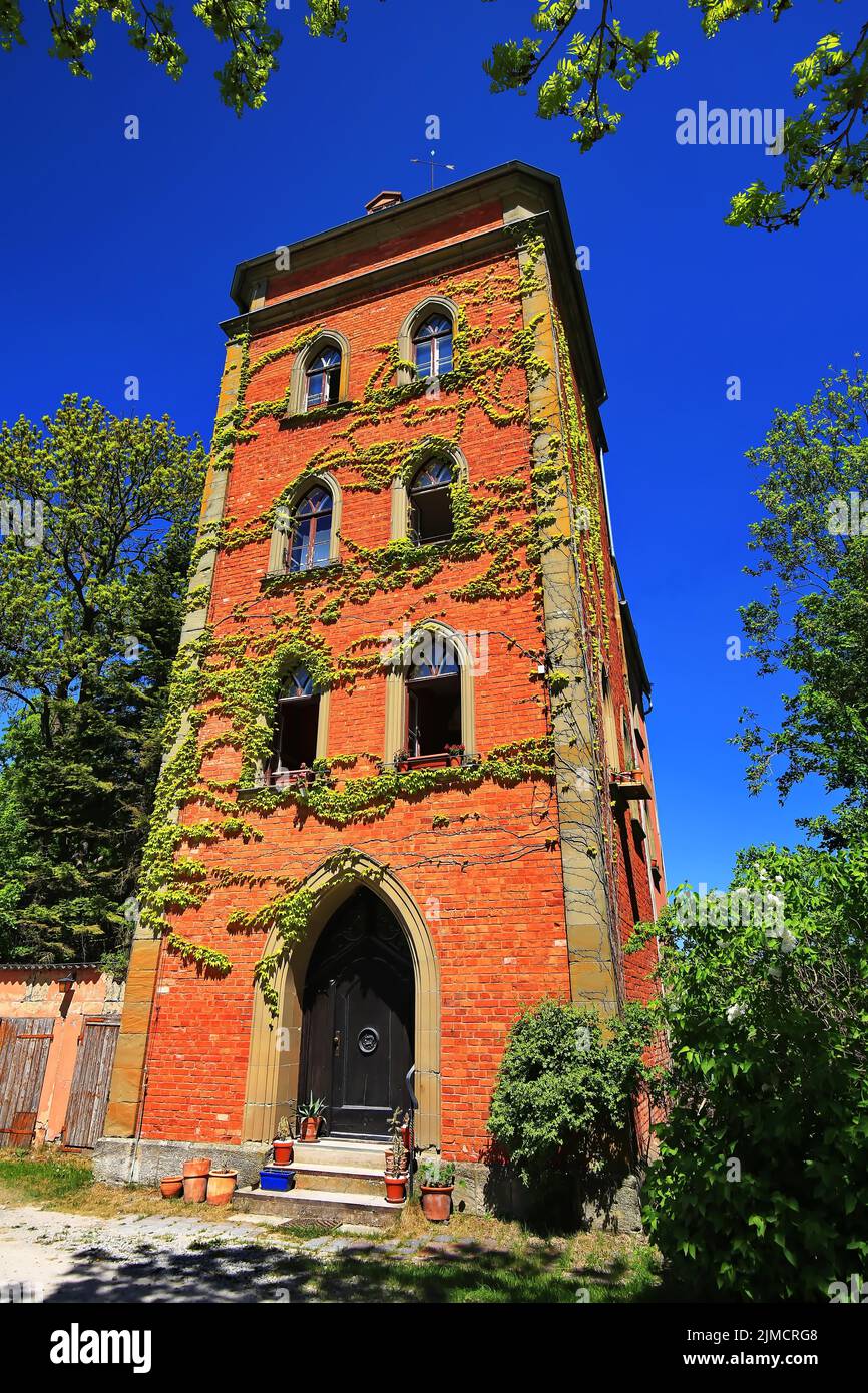 Historic red castle tower under a steel blue sky. Schillingsfuerst ...