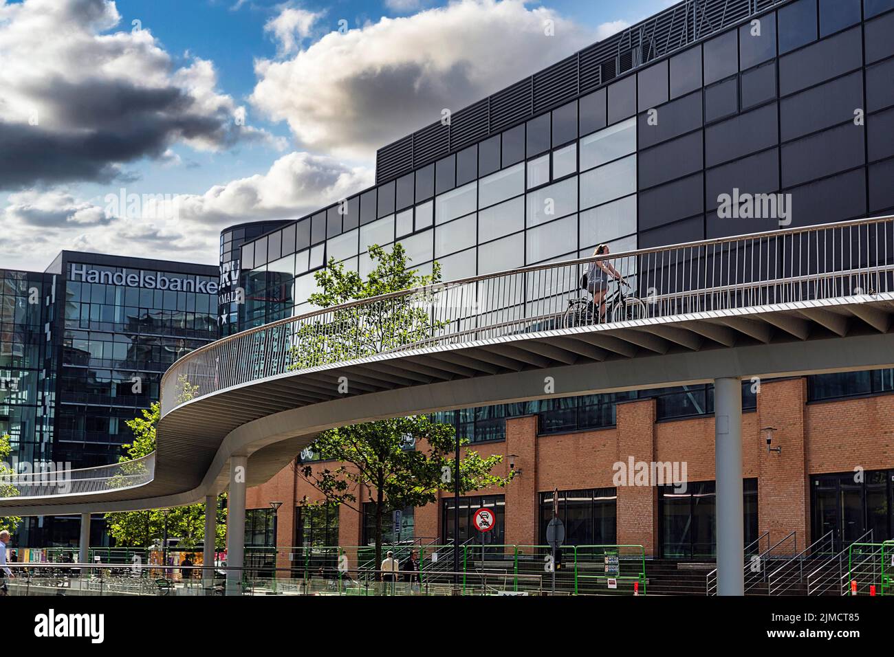 Cyclists on bridge over inner harbour basin, snake-shaped Cykelslangen ...