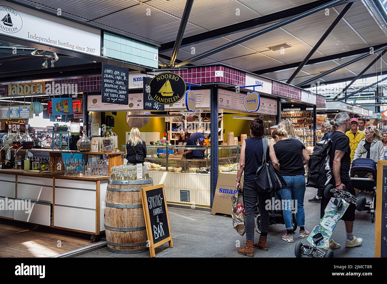 Visitors in the Torvehallerne market hall with street food and ...