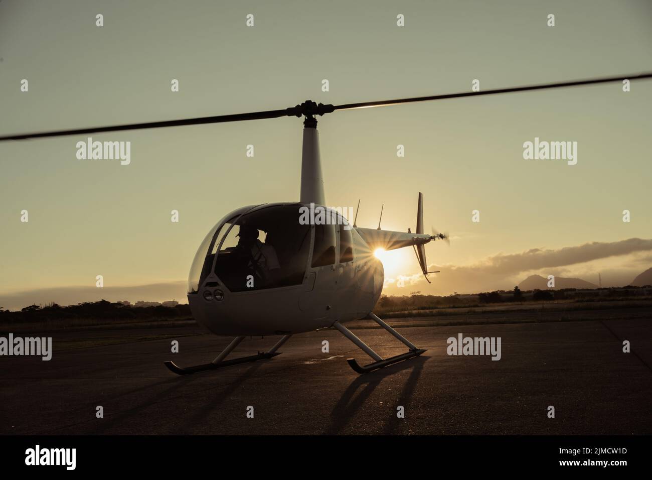 Helicopter at sunset. Airfield Stock Photo - Alamy