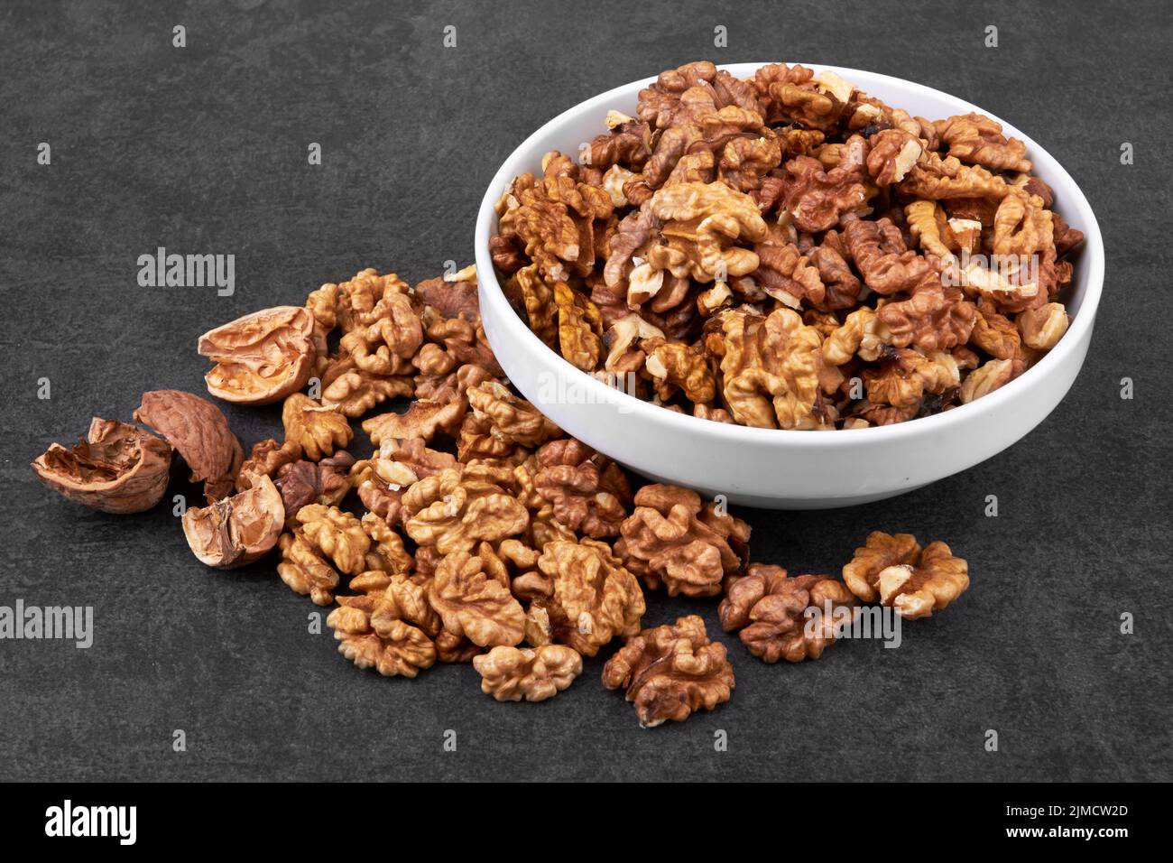 Pile of walnuts on a stone black surface Stock Photo - Alamy