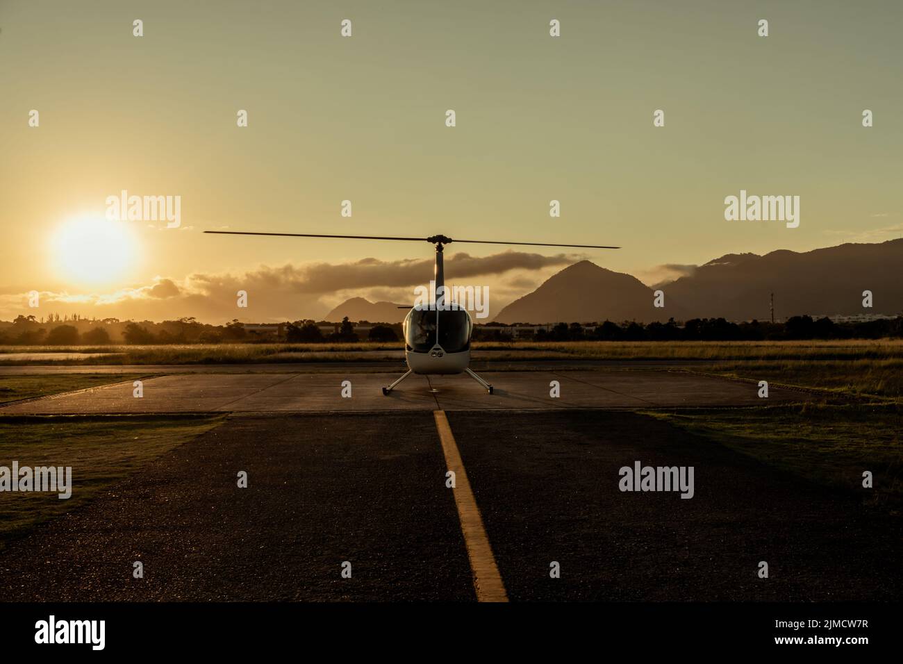 Helicopter at sunset. Airfield Stock Photo - Alamy