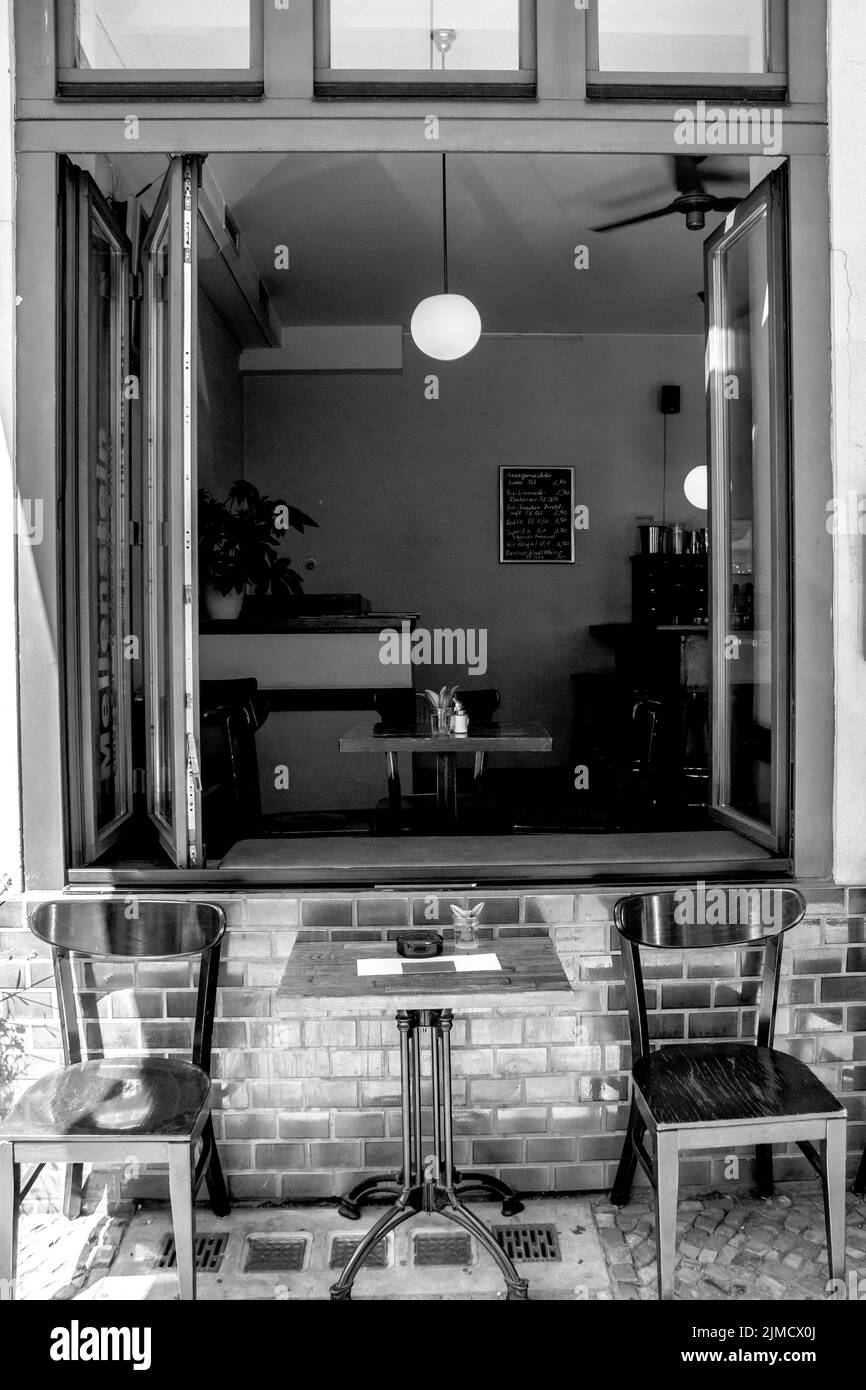 Black and white, view through the open window into a bistro, Berlin ...