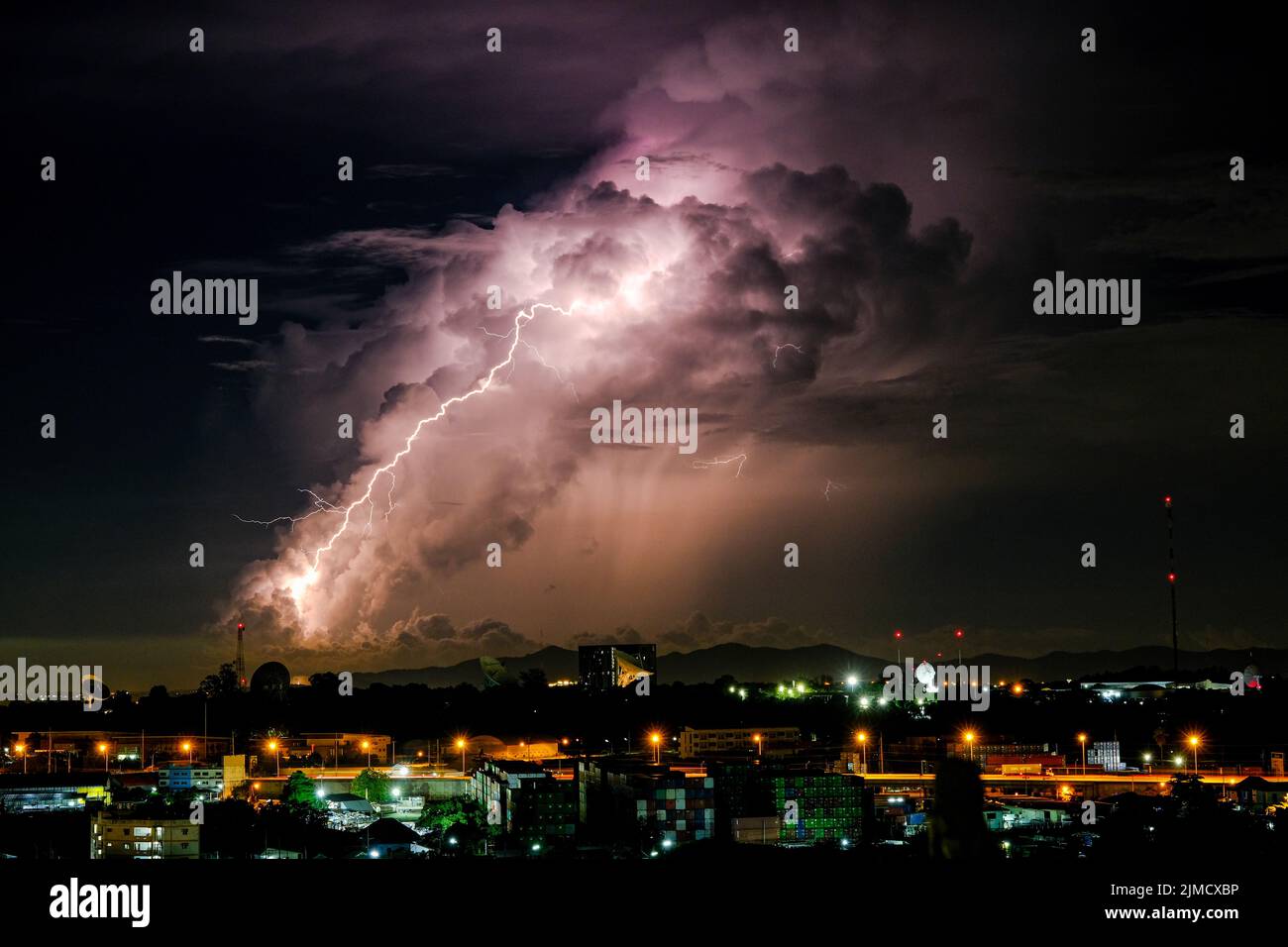 Cloudy with Bright lightning bolt strikes in the rural landscape of ...