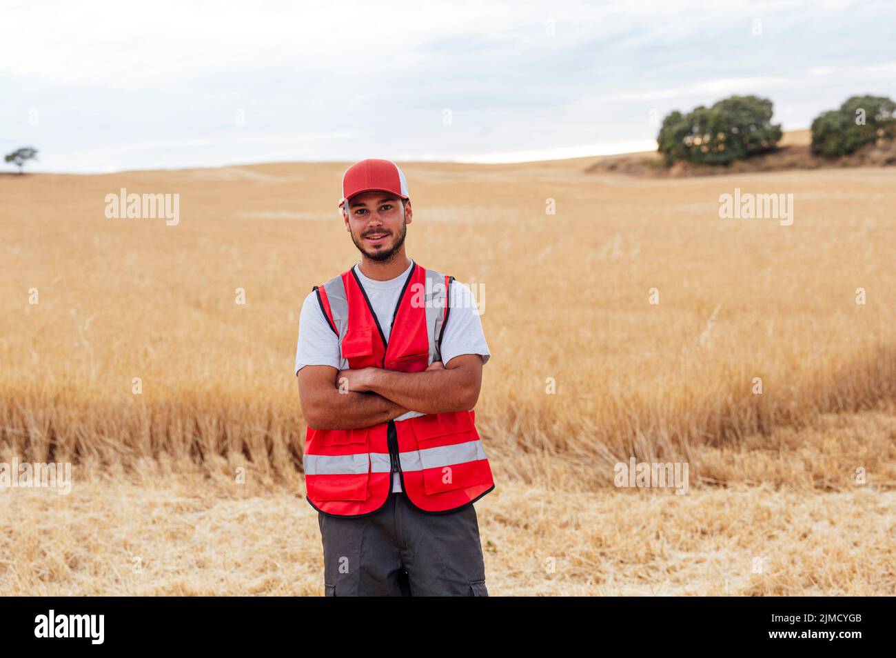 Male farmer in uniform standing looking at camera in agricultural ...