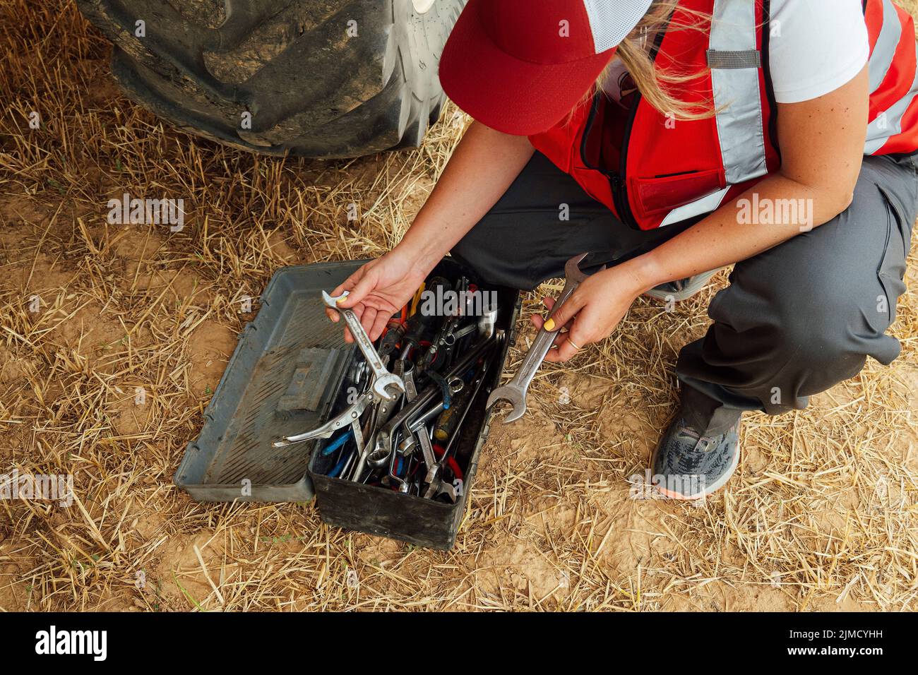 From above of crop unrecognizable female worker in uniform choosing ...
