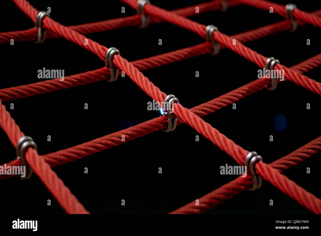 Ropes in the playground. Climbing net, shot close-up. Ropes fastened ...