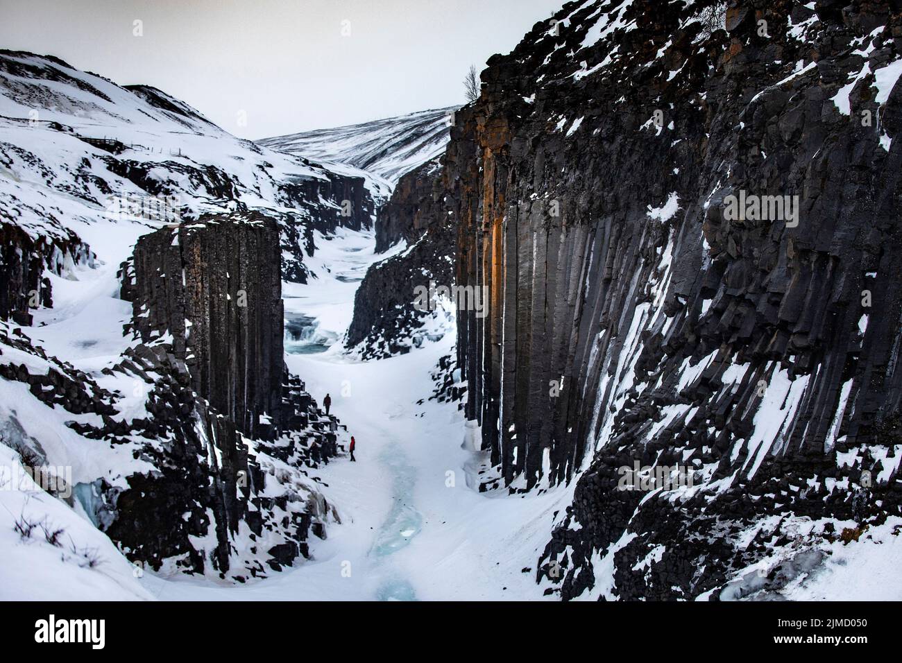 Unrecognizable travelers walking in between spectacular scenery of ...