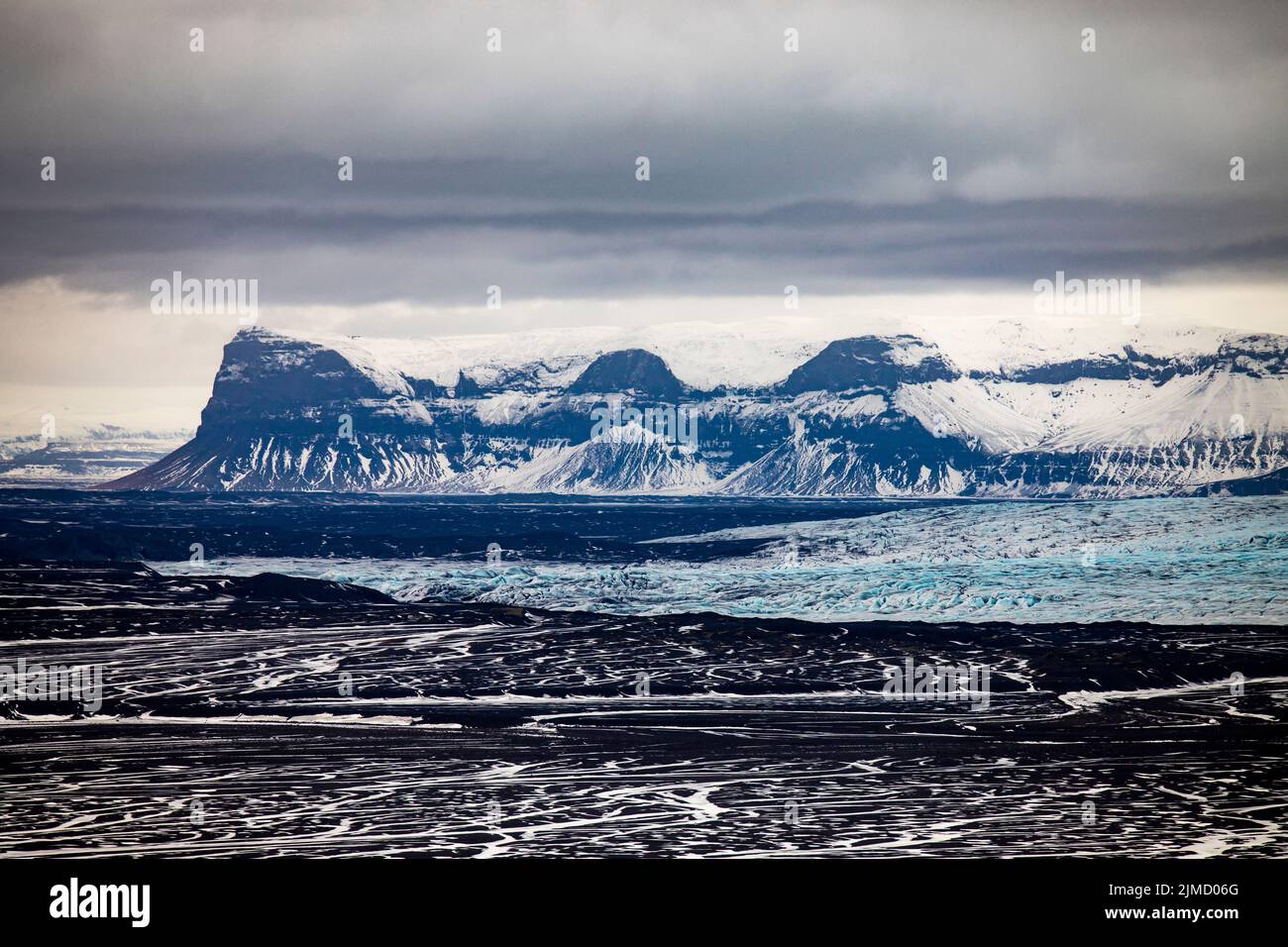 Arctic landscape of blocks of ice floating on lake surrounded by rough ...