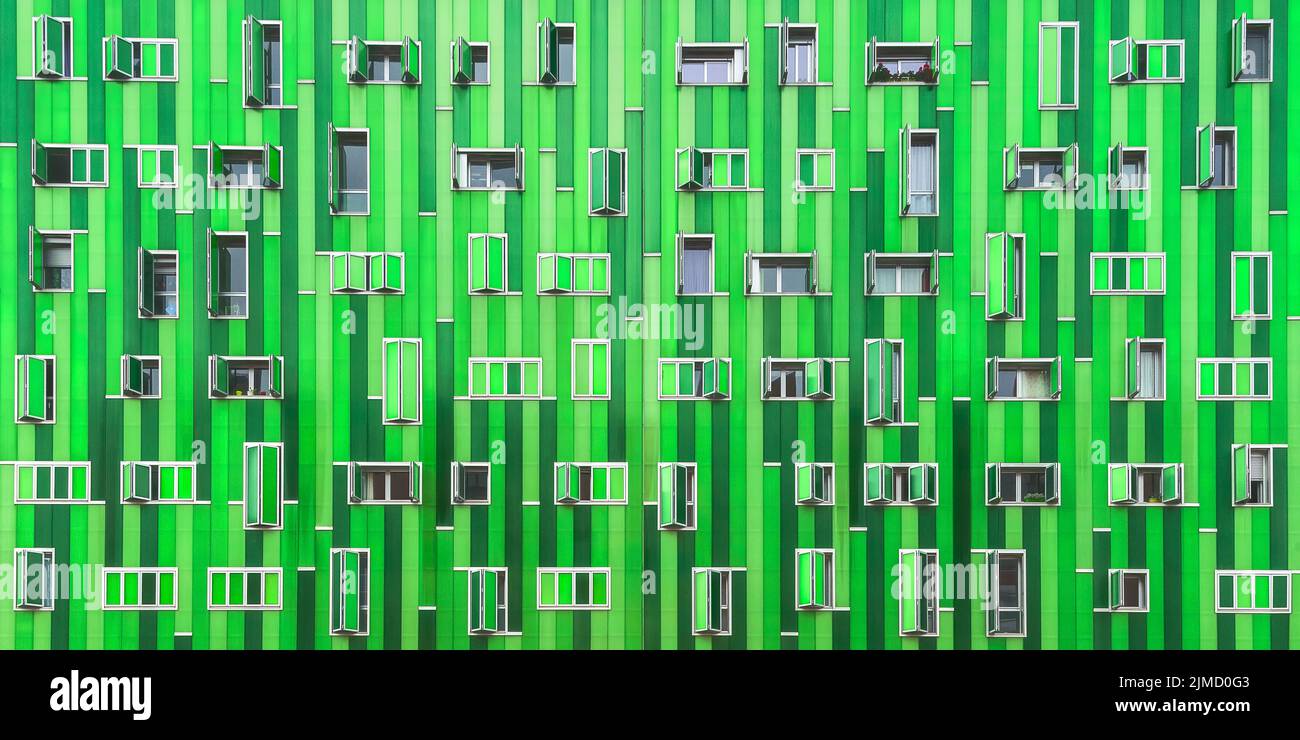Contemporary building with vivid green facade and opened windows Stock ...