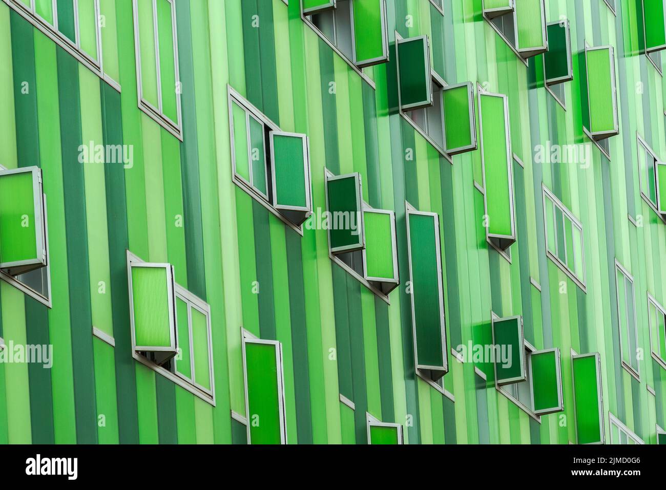 Contemporary building with vivid green facade and opened windows Stock ...