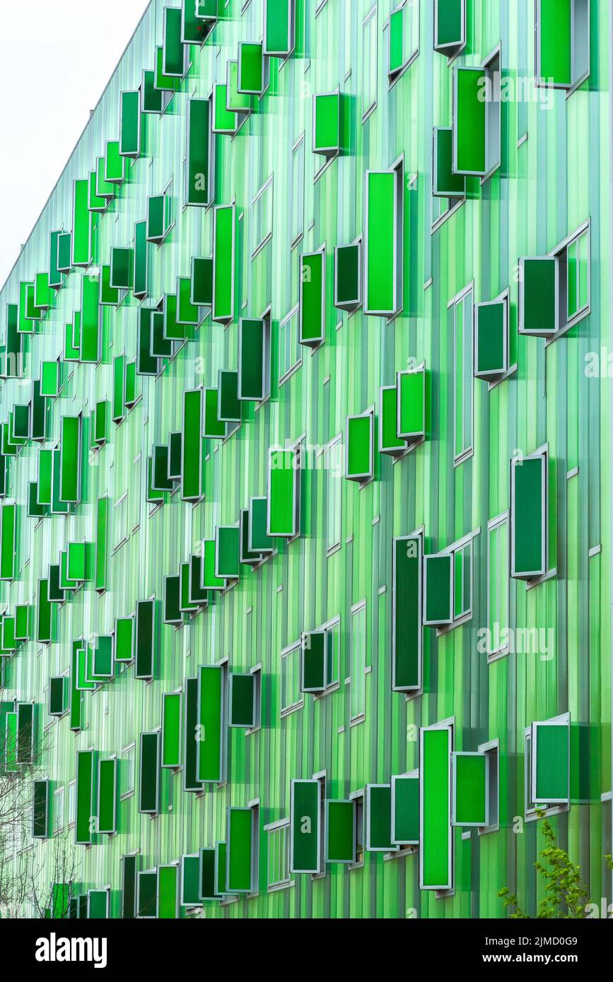 Contemporary building with vivid green facade and opened windows Stock ...
