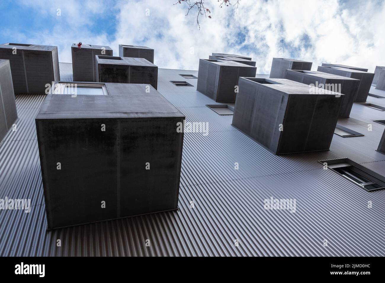 From below exterior of residential house with windows and various gray ...