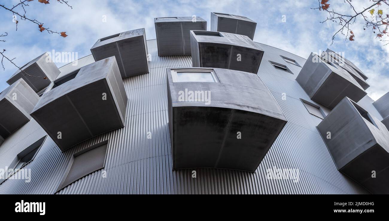 From below exterior of residential house with windows and various gray ...