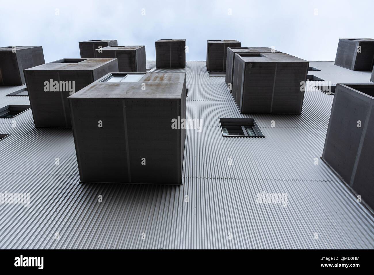 From below exterior of residential house with windows and various gray ...