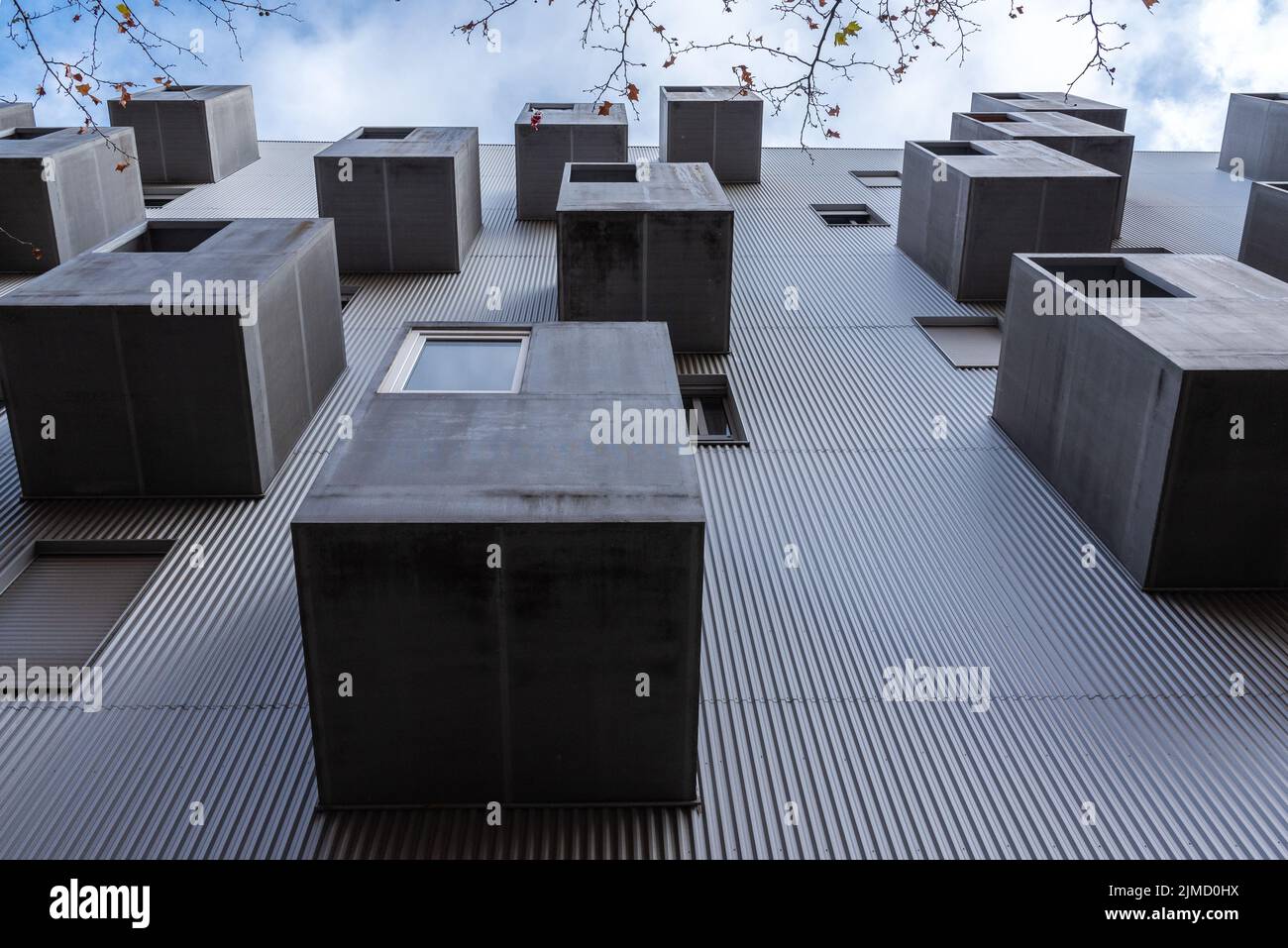 From below exterior of residential house with windows and various gray ...