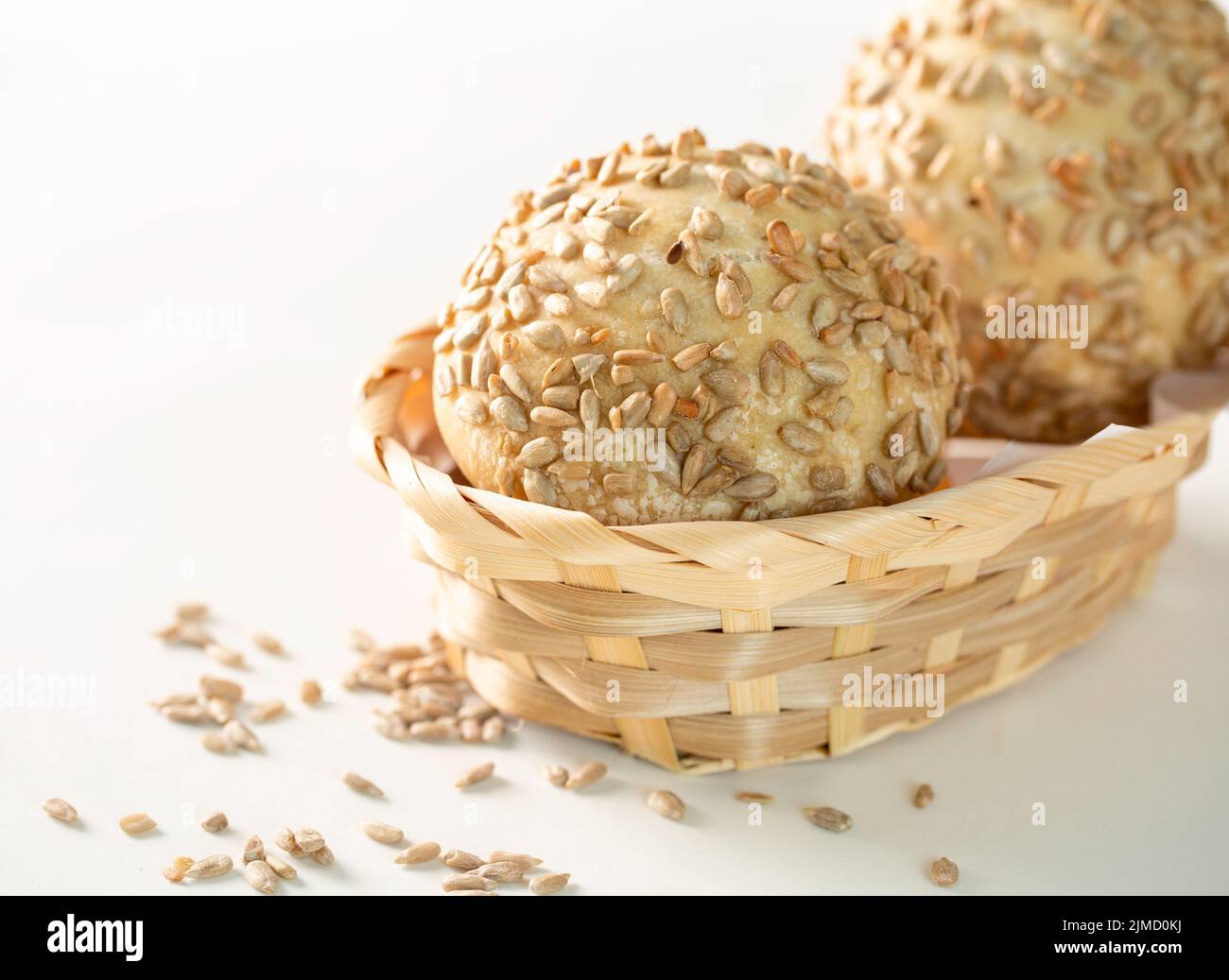 High angle of freshly baked buns with sunflower seeds served in wicker ...