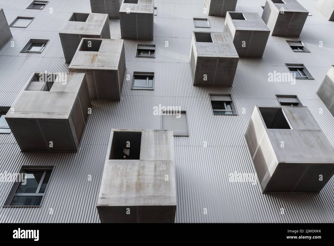 From below exterior of residential house with windows and various gray ...