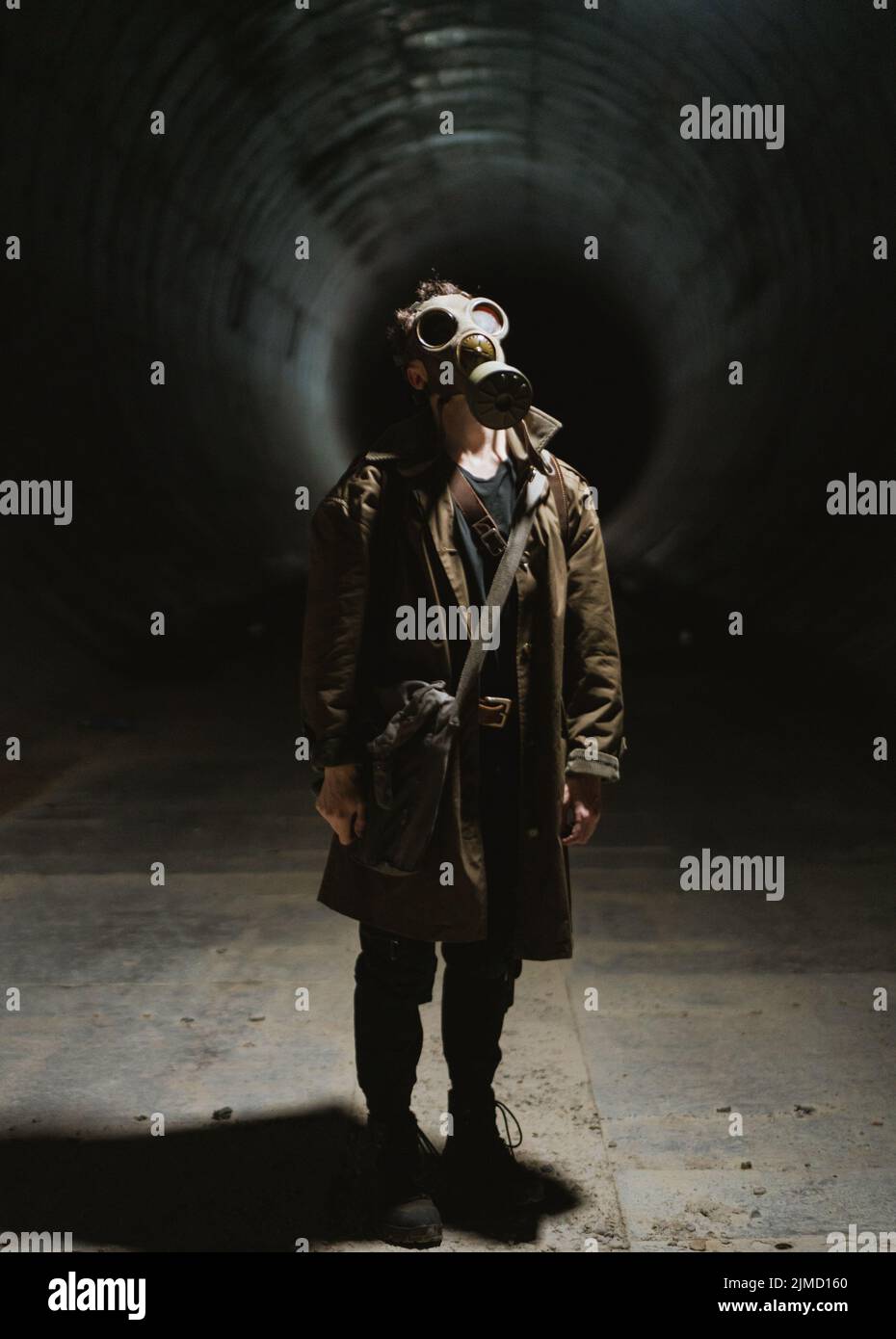 Full body of unrecognizable male explorer in gas mask in dark ...