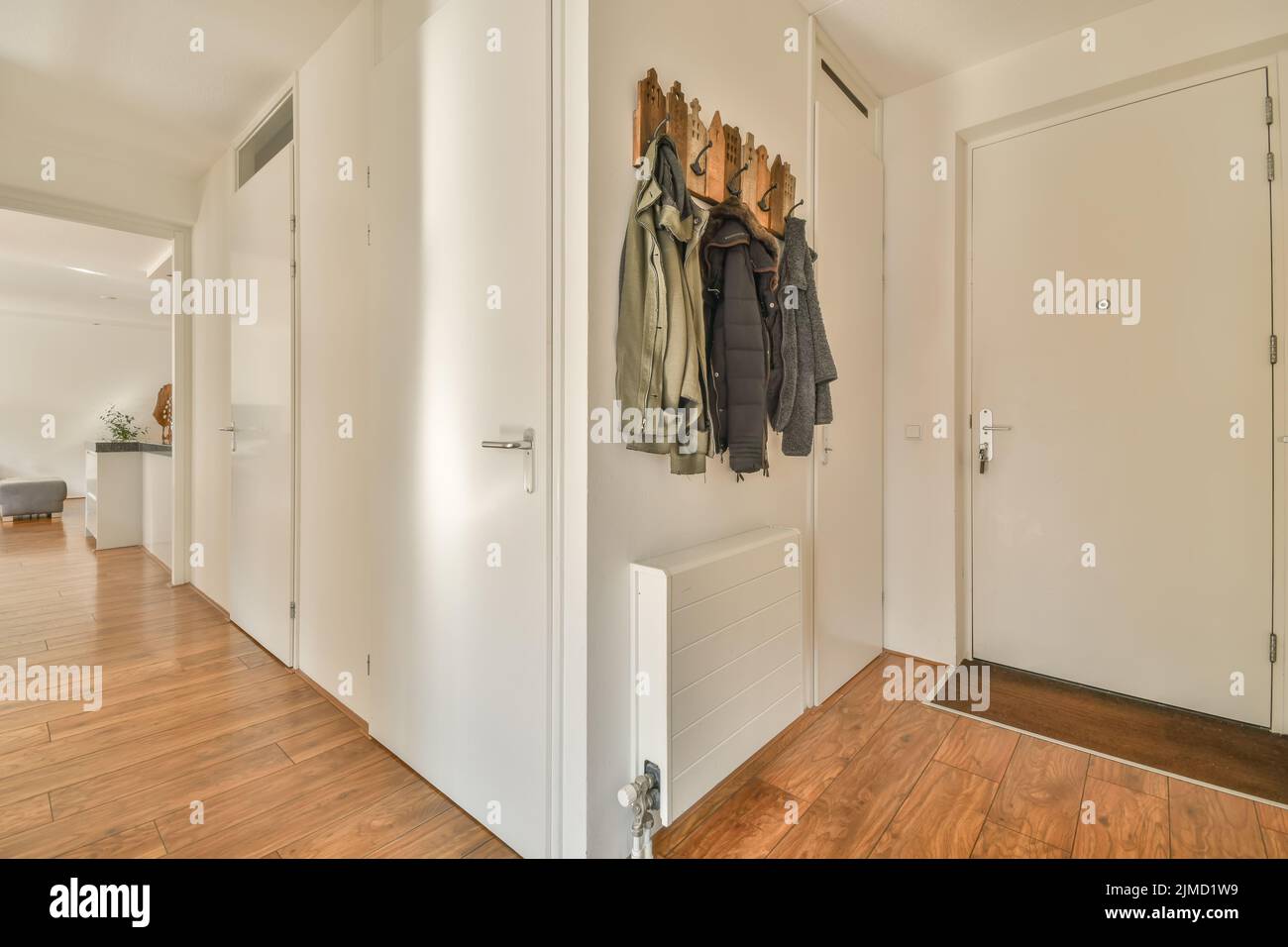 Interior passage way with coat rack on wall in modern house Stock Photo ...