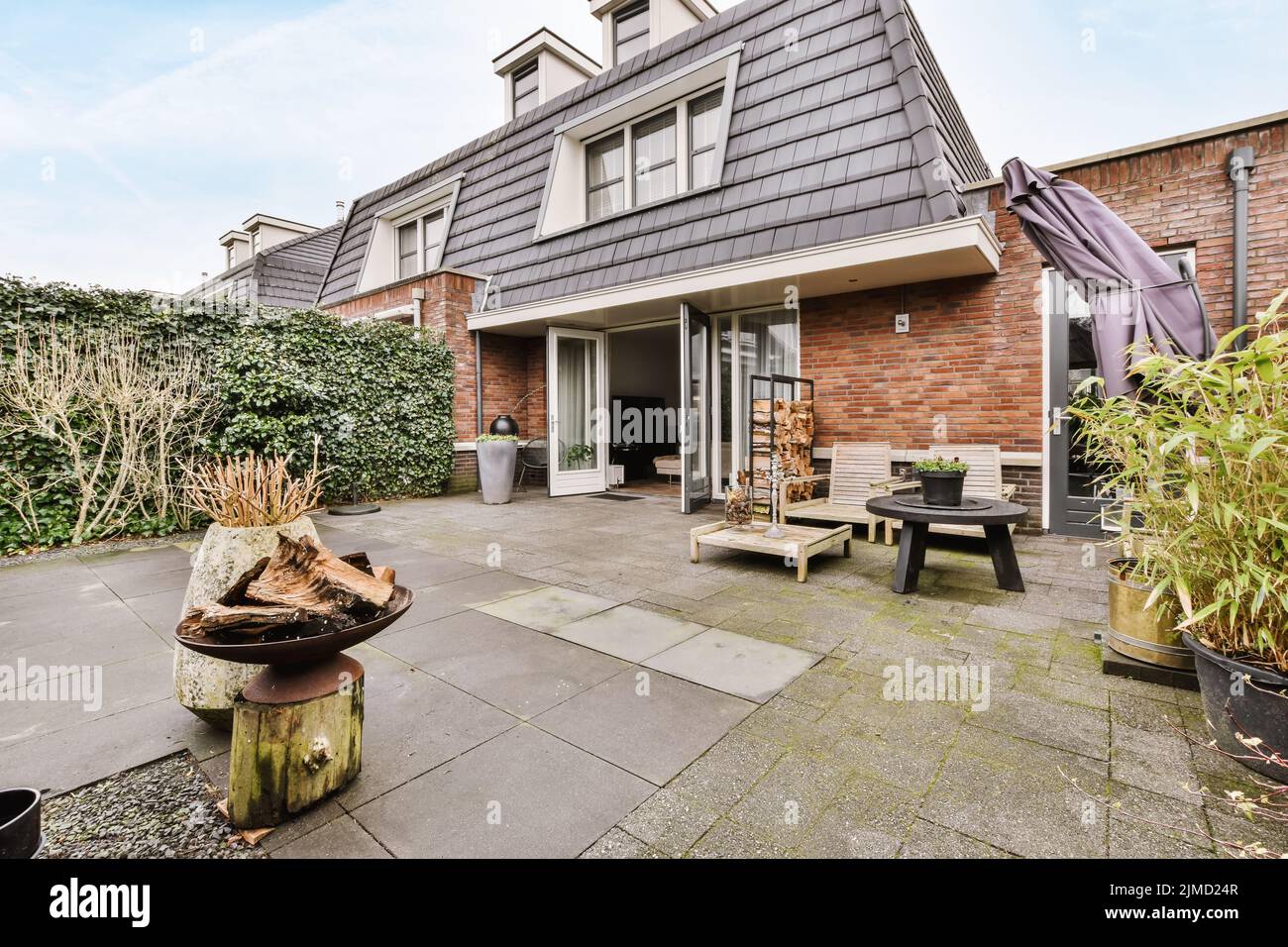Backyard of a house with green plants under a cloudy sky Stock Photo ...