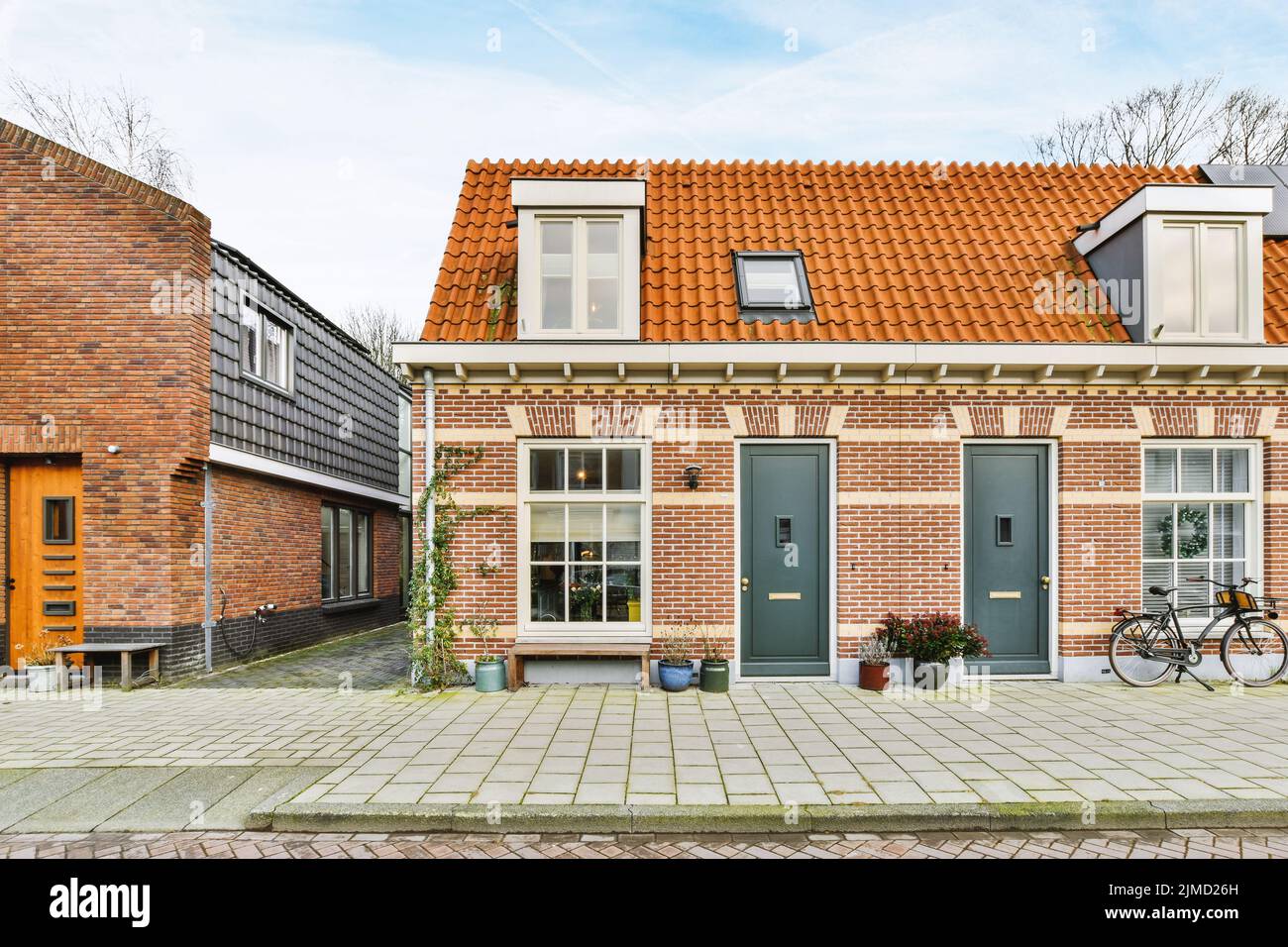 Front view of a street with houses lined up next to pavement under a ...