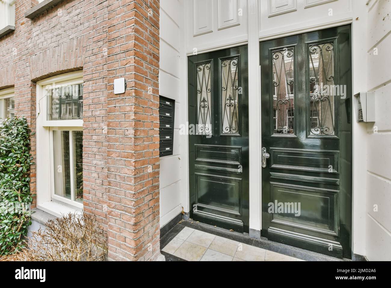 Side view of some green entrance doors to a house Stock Photo - Alamy