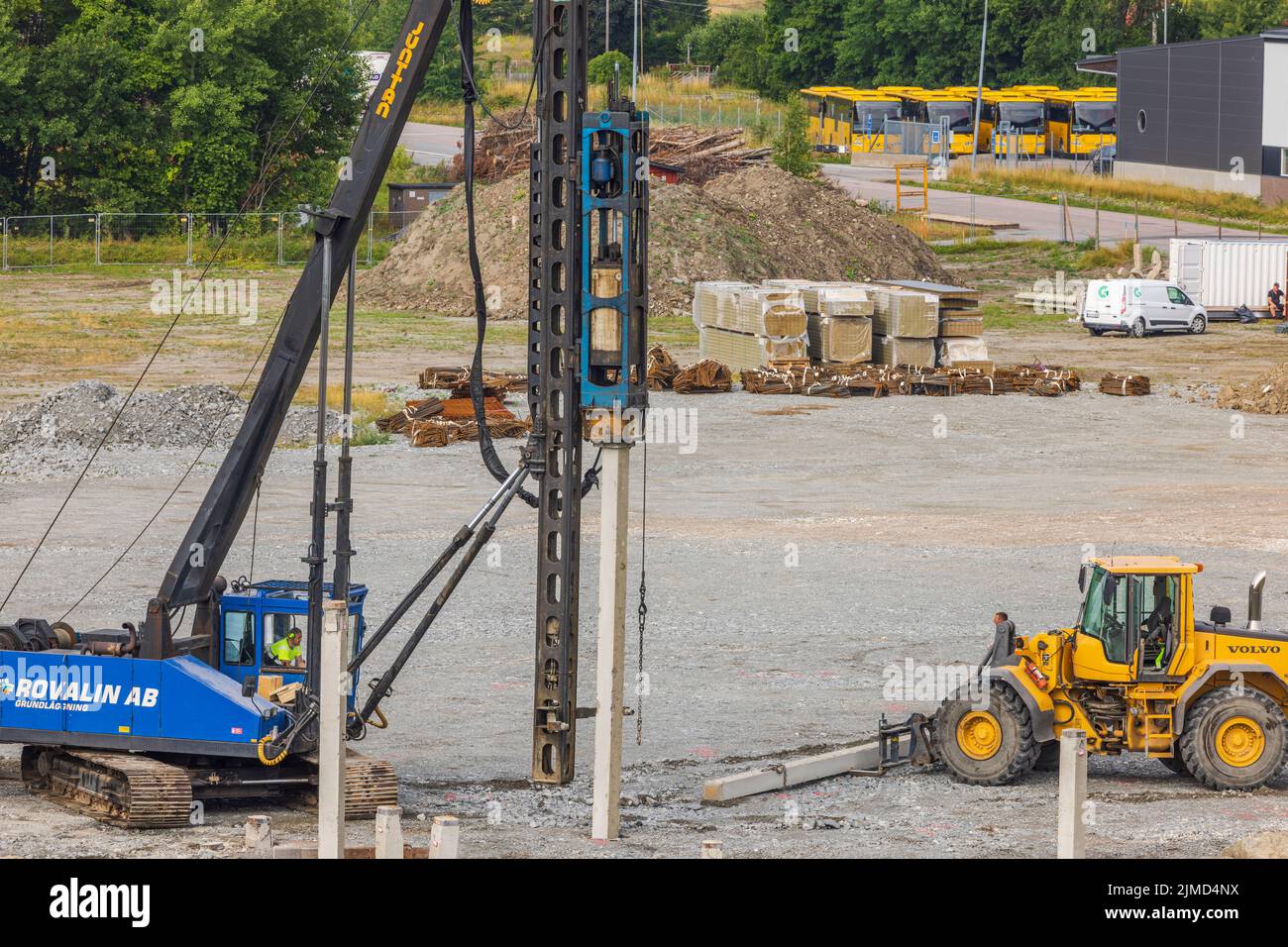 View of pile driving machine driving piles into ground construction ...