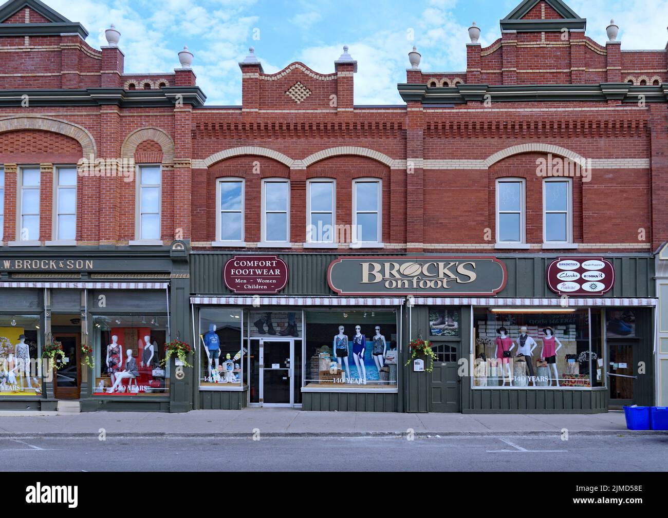 Old fashioned small town main street stores in ornate brick building ...