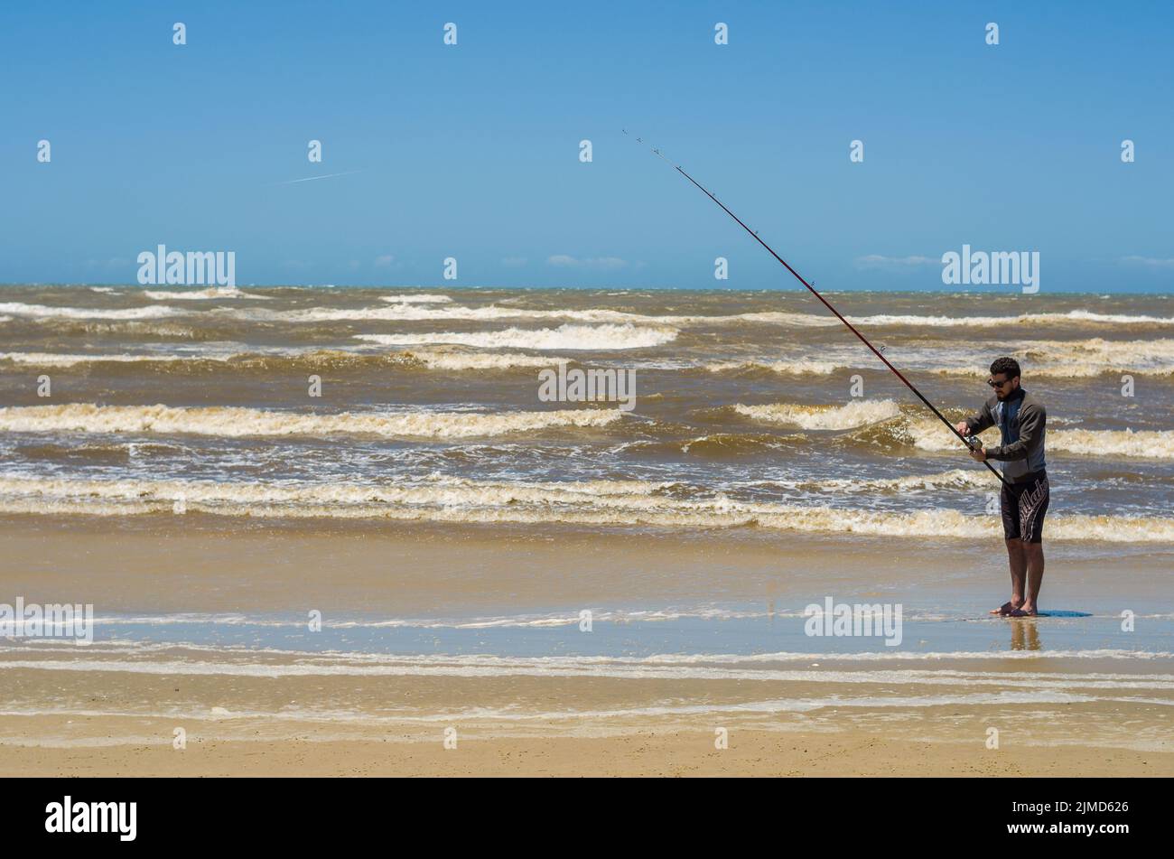 Men fishing on beach sunset hi-res stock photography and images - Alamy