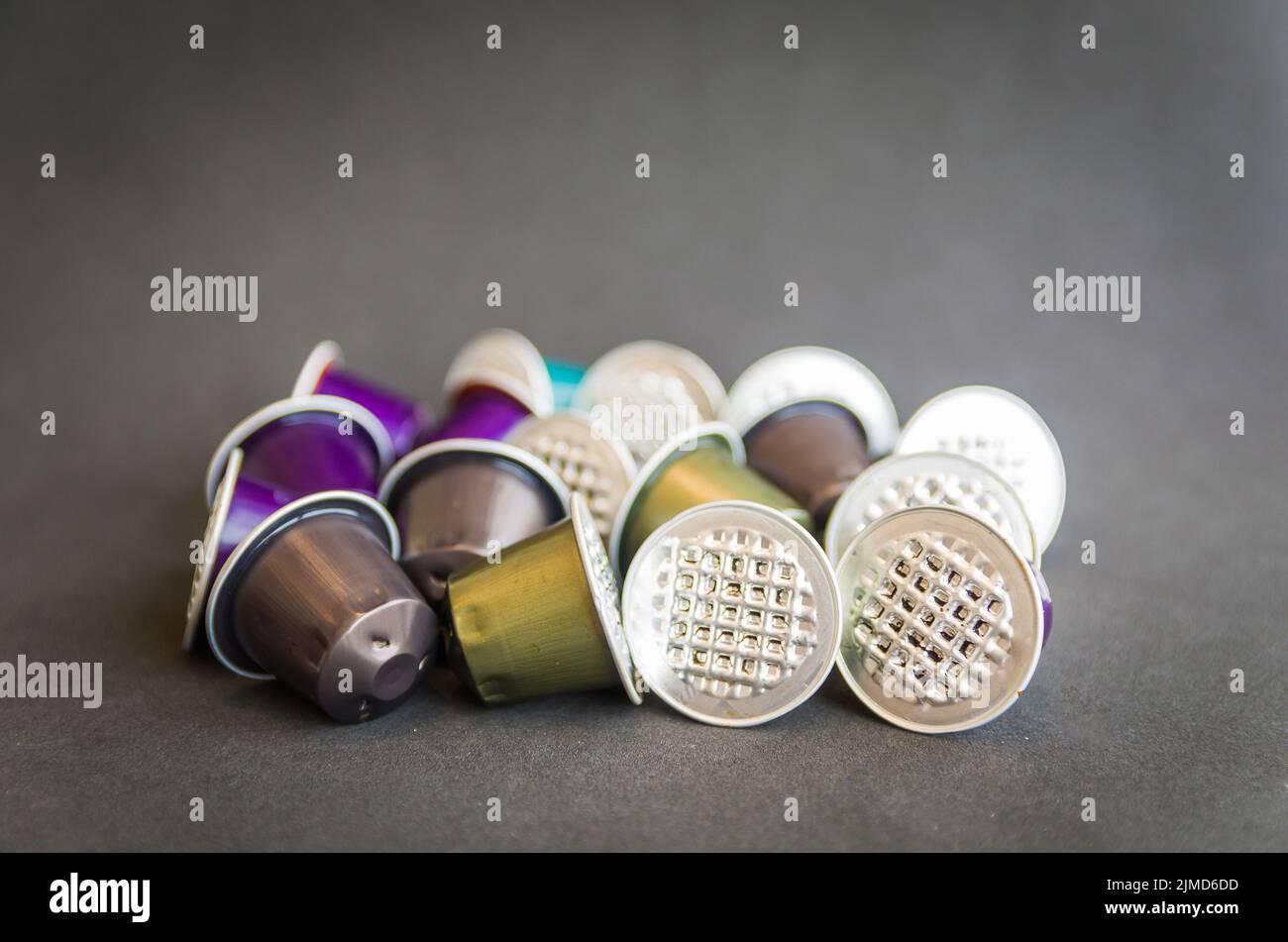 Colorful espresso coffee capsules used on black background, recycling ...