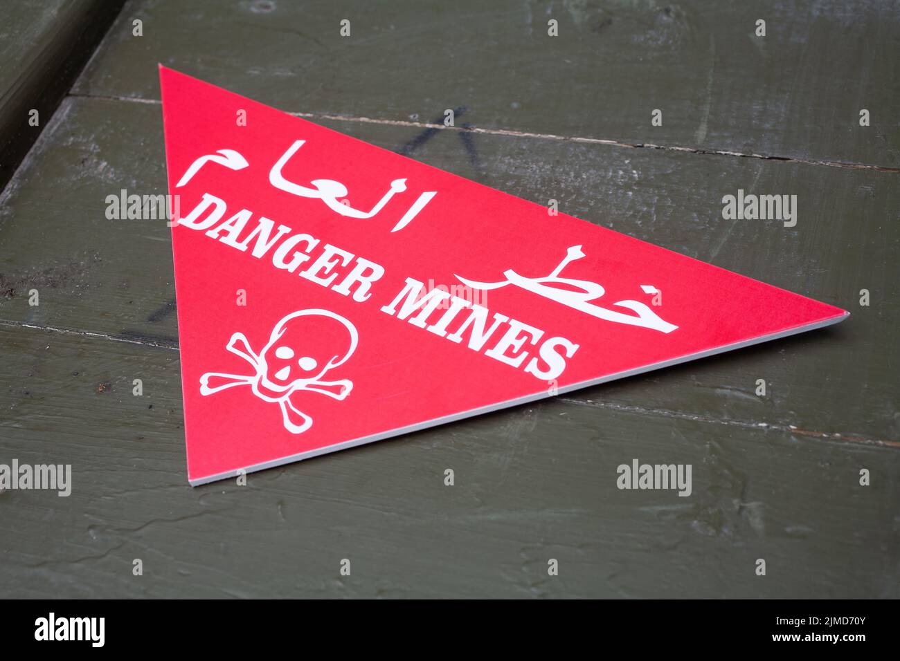 Arabic/English minefield warning red sign - Danger Mines. White skull ...
