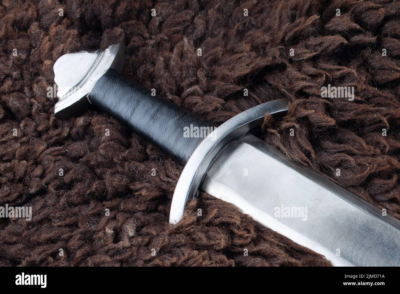Viking Age sword on sheep fur background Stock Photo - Alamy