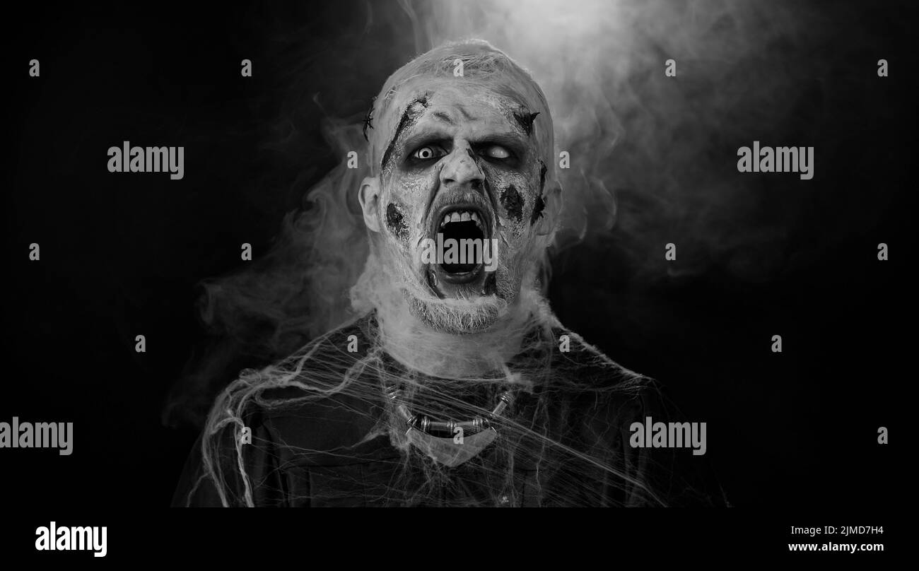 Creepy man with bloody scars face, Halloween stylish zombie make-up ...