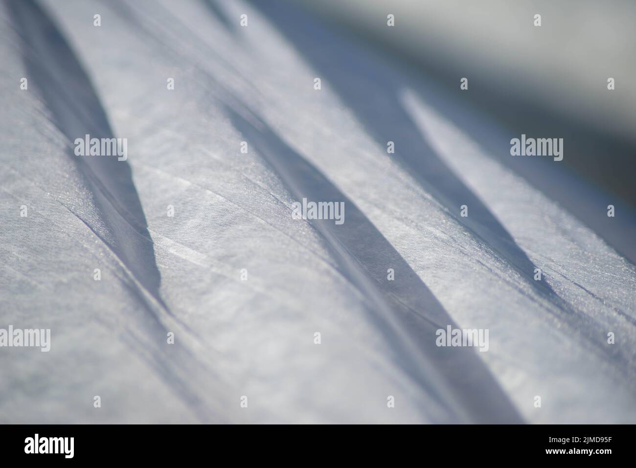 White garden fabric ripples softly and shines in the wind Stock Photo ...