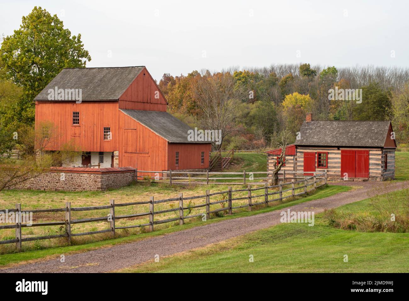 Red barn and log cabin on dirt road at historic Daniel Boone Homestead ...