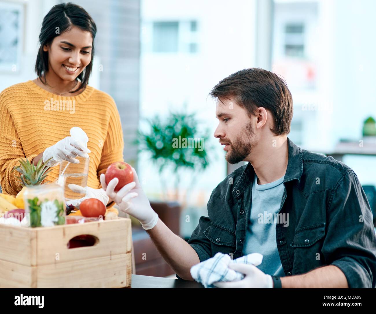 Times of crisis need extra care. a young couple disinfecting their ...