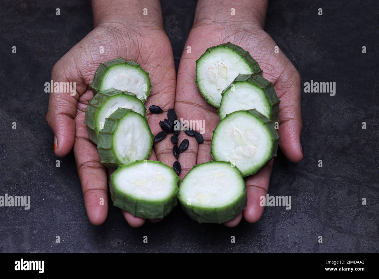 Ridges Gourd stock with seed on hand for farming Stock Photo - Alamy
