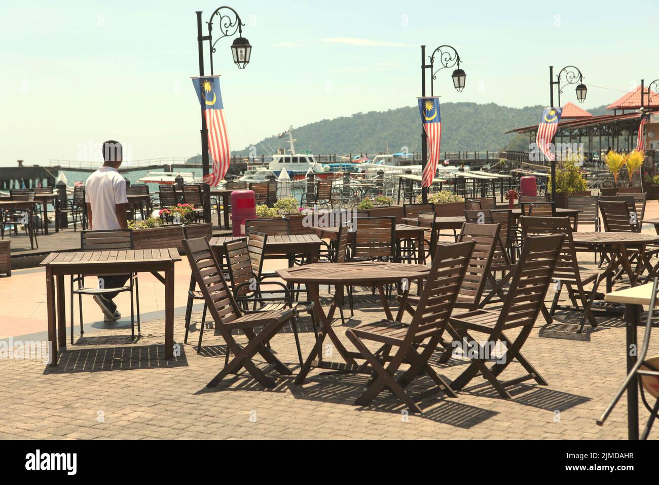 A man walking through a seaside cafe on a viewing platform at Jesselton ...