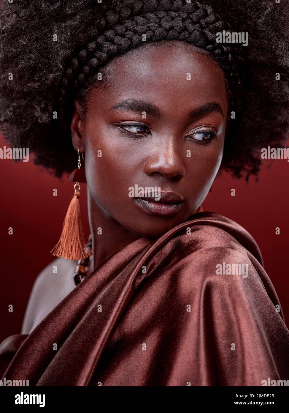 Your culture is beautiful. a beautiful young woman posing against a red ...