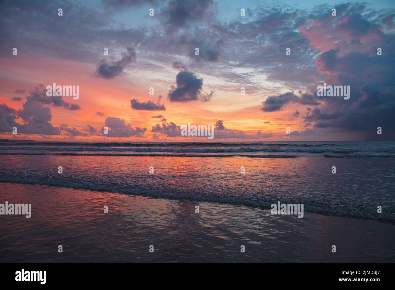 Gorgeous fiery red sunset view on Kuta beach Stock Photo - Alamy