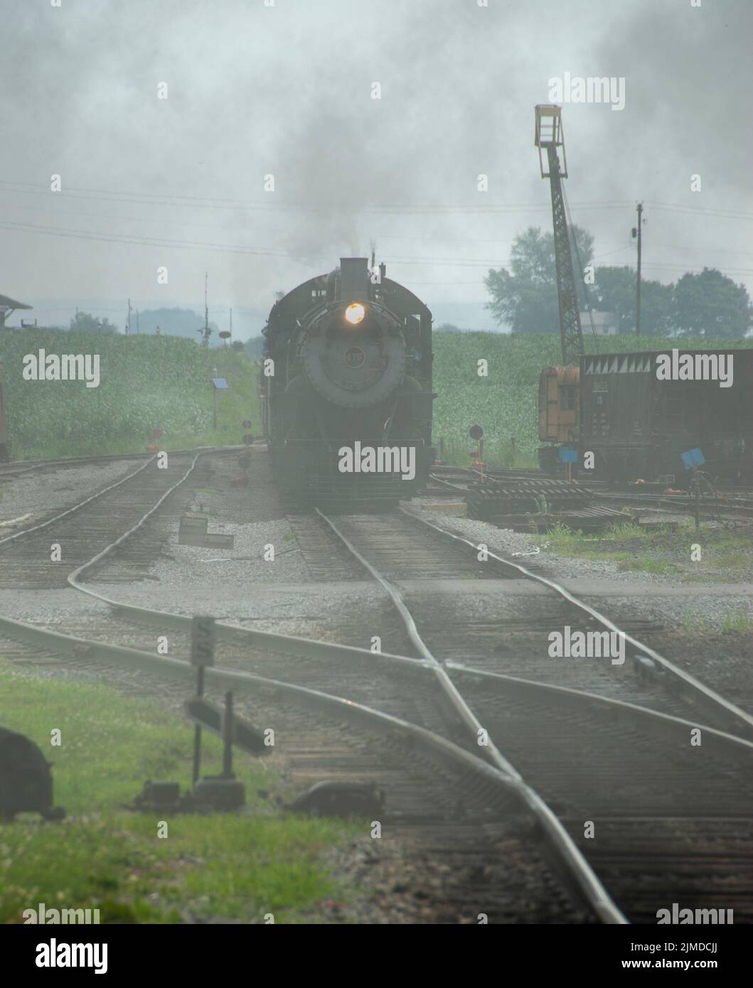 Steam Engine Locomotive with Passenger cars Arriving into Station Stock ...