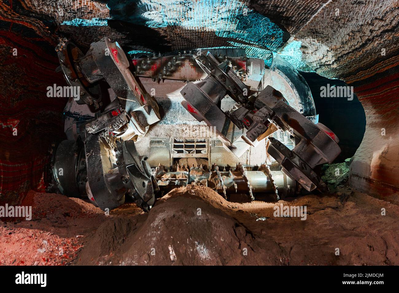 Illuminated mining drilling machine in salt quarry tunnel Stock Photo ...